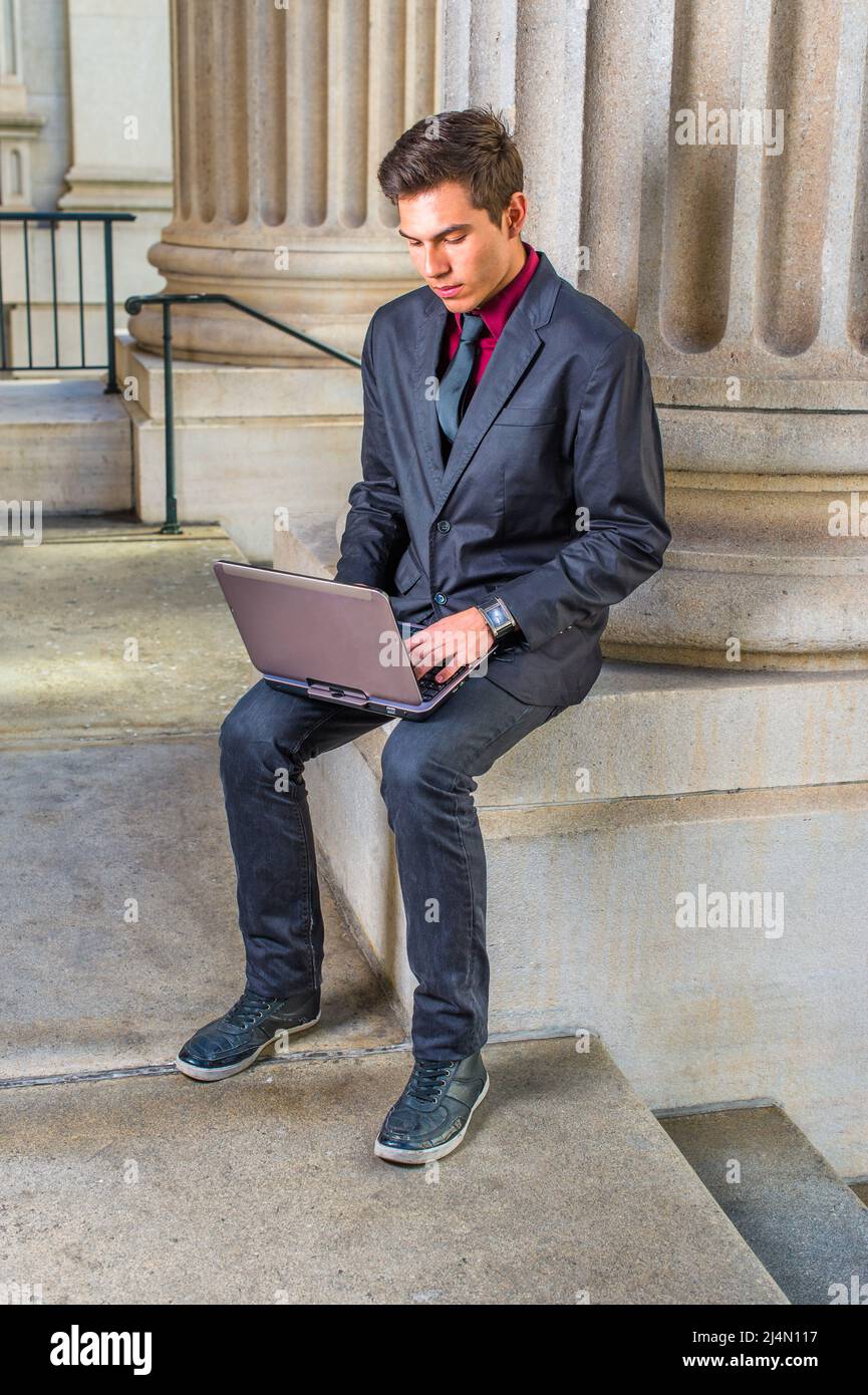 Dressing in a red undershirt, a black blazer, jeans, a black tie, a ...