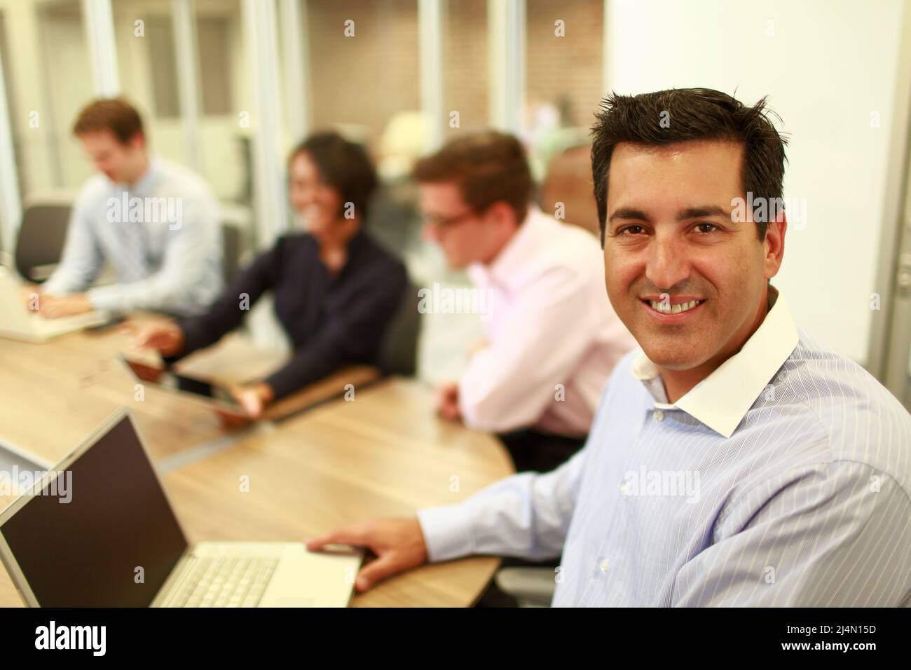 Young professional man with co-workers meeting in conference room Stock ...