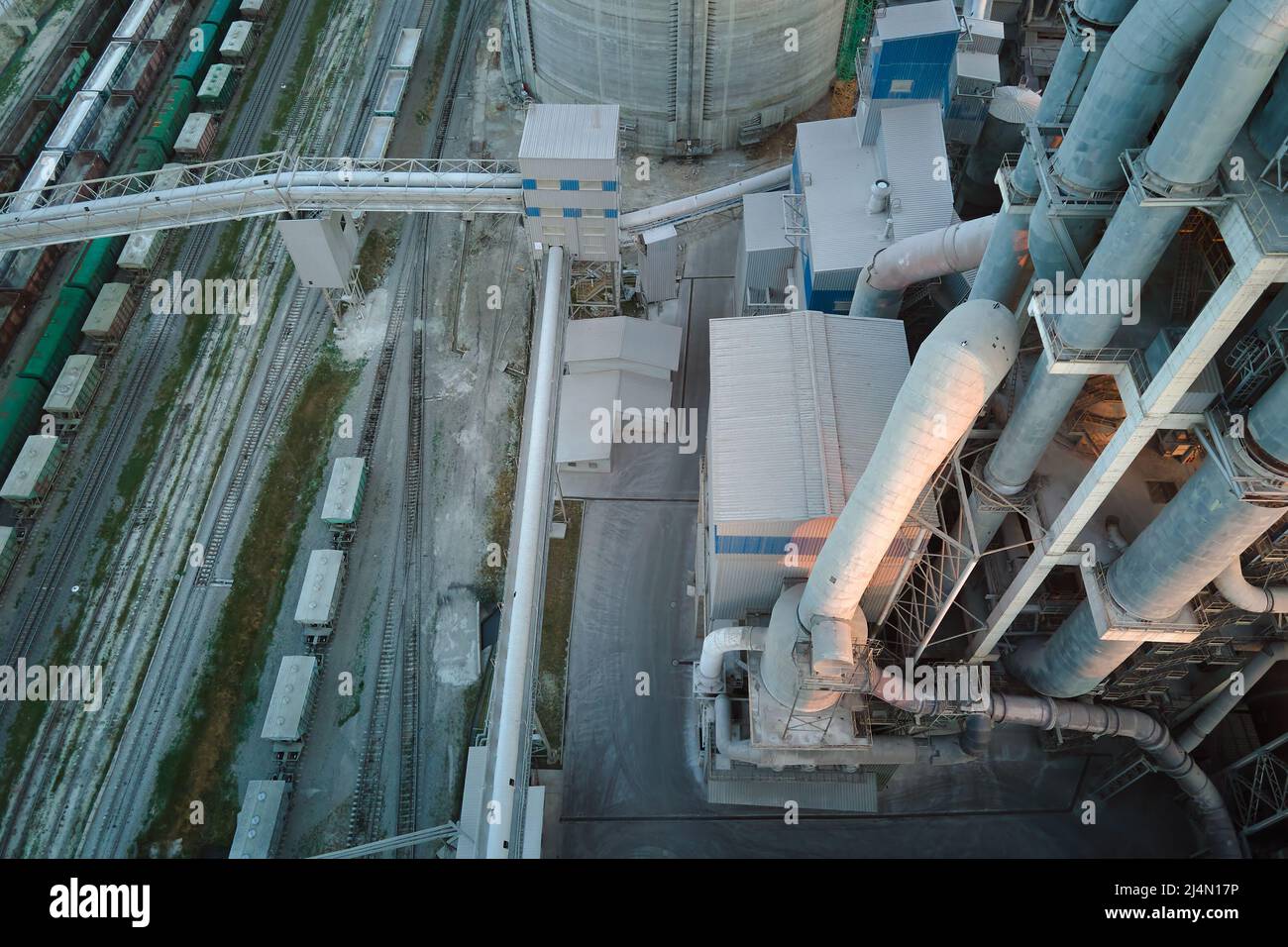 Cement plant with high factory structure and tower cranes at industrial ...