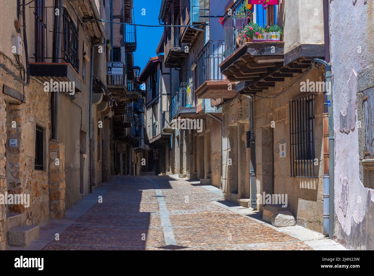 Timber houses alongside a narrow street in Miranda del Castanar village ...