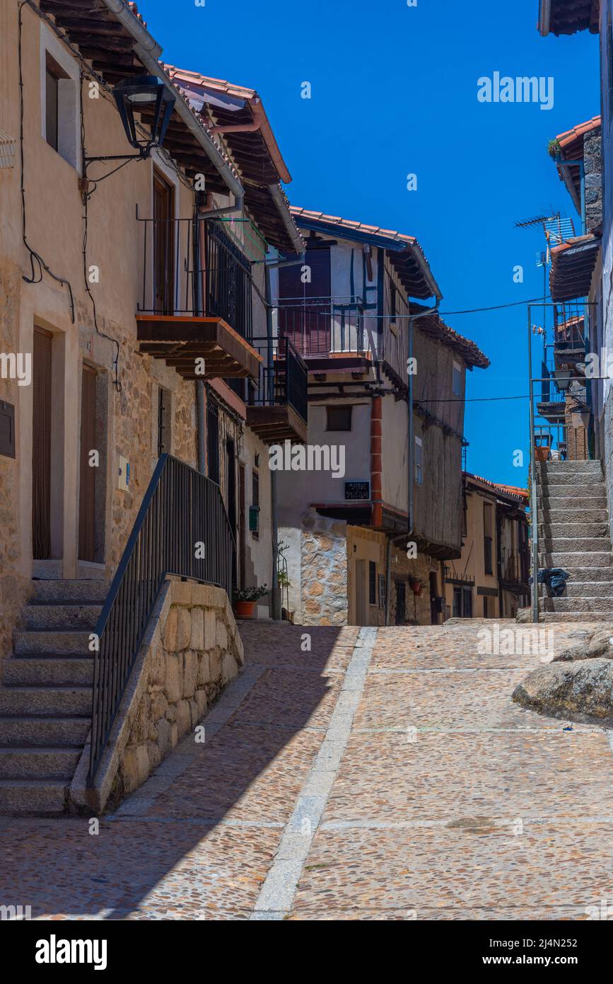 Timber houses alongside a narrow street in Miranda del Castanar village ...