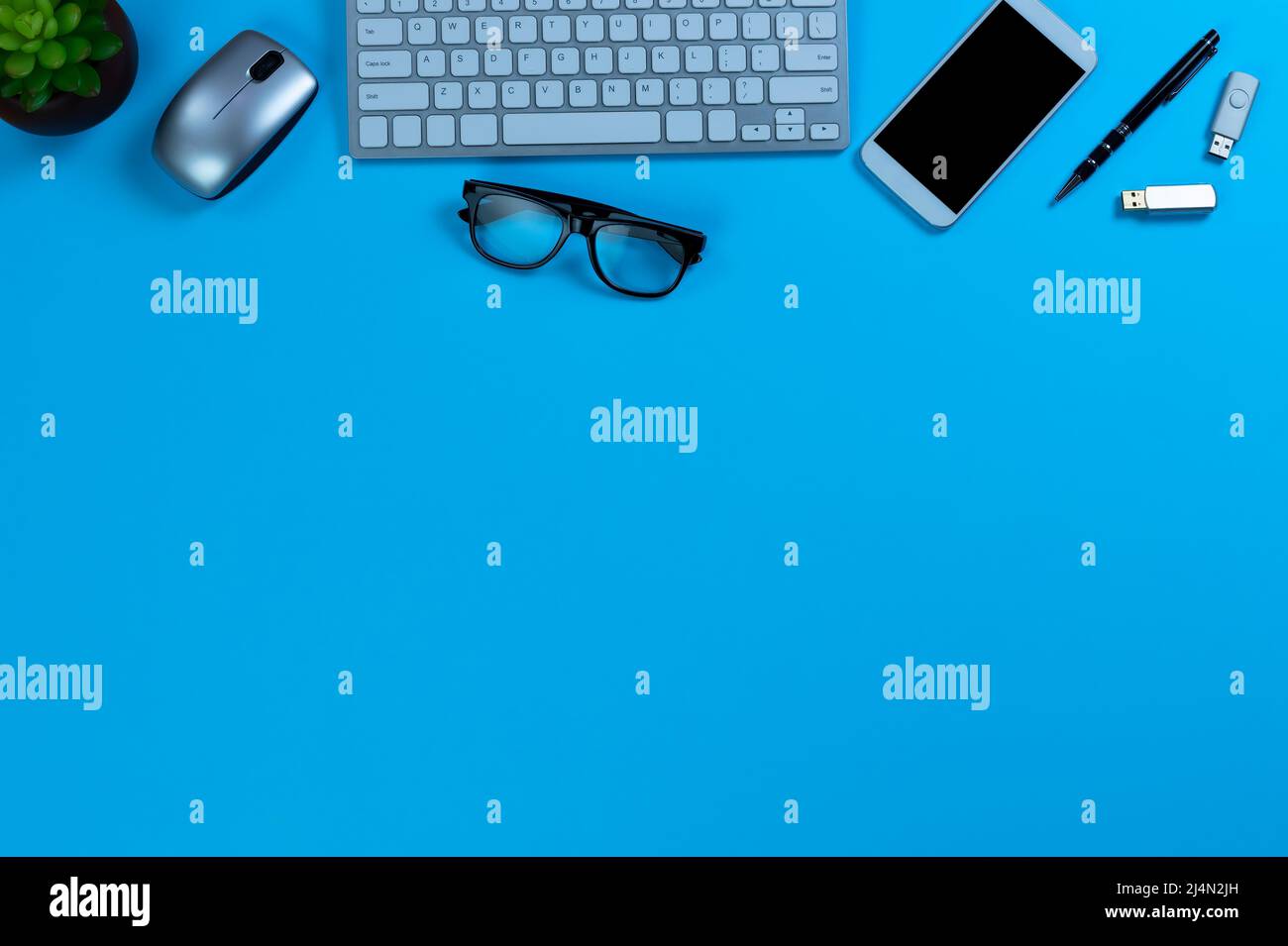 Blue office desk with computer and other supplies for work or school ...