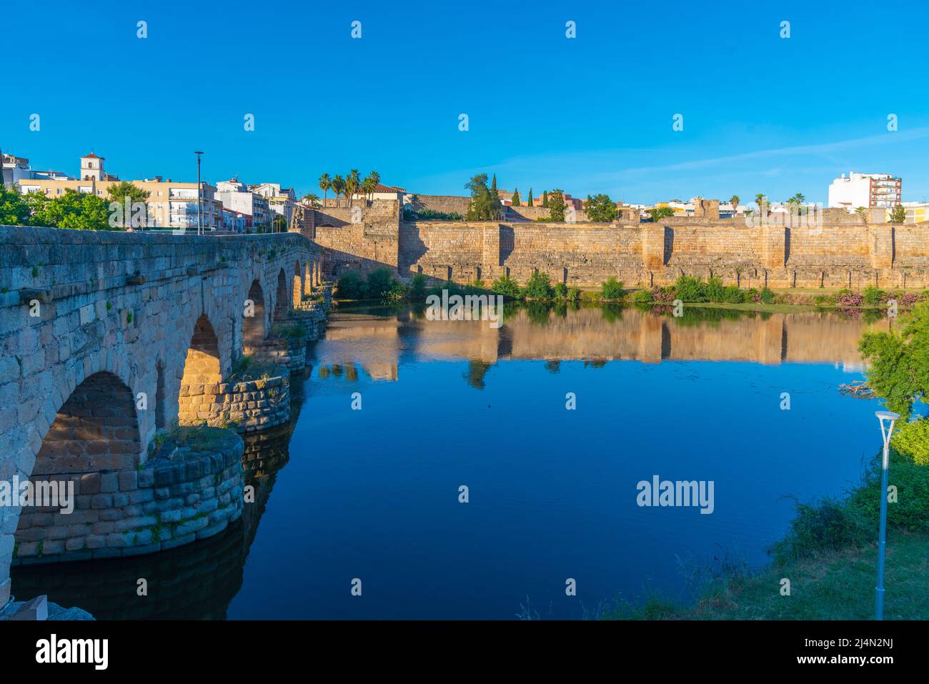 Roman bridge and Alcazaba fortress alongside river Guadiana in Merida ...