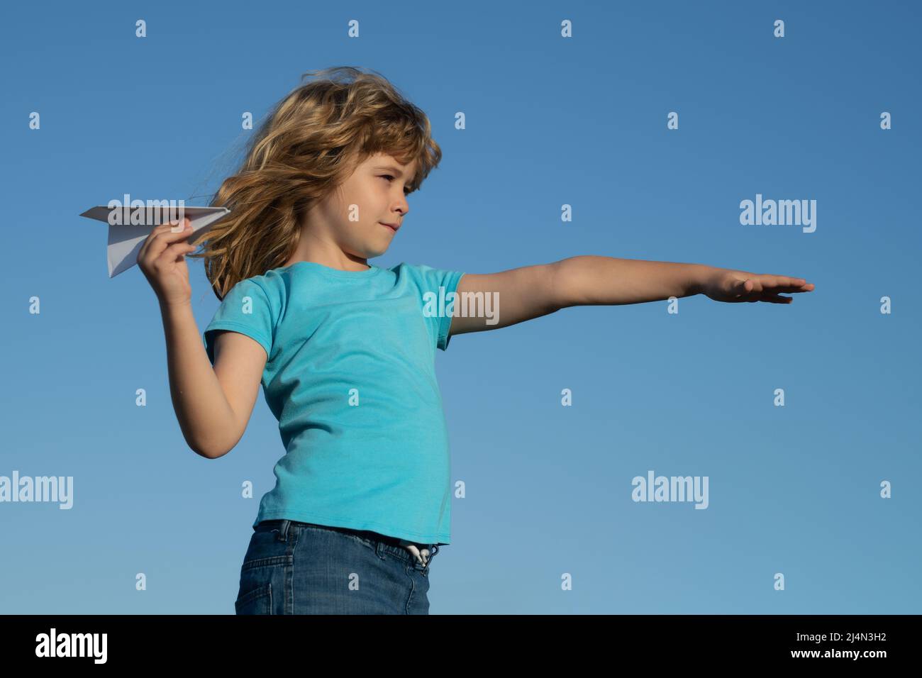 Child throwing paper plane hi-res stock photography and images - Alamy