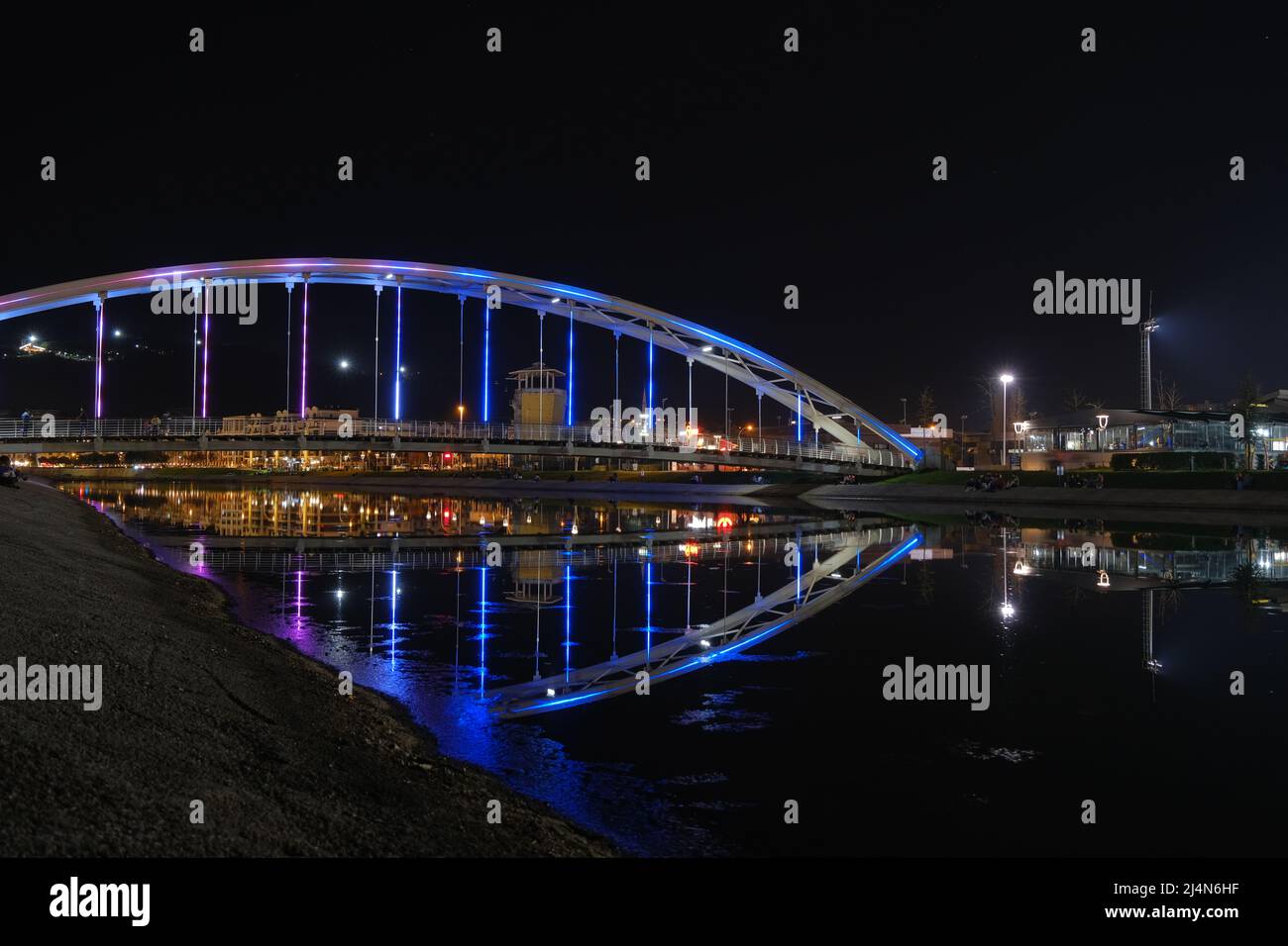 Night city photo. city lights and lightning bridge on water and water ...