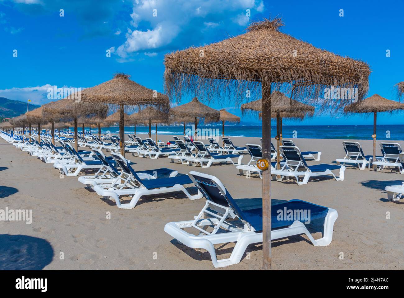 Sunbeds and umbrellas at Playa de Venus at Marbella, Spain Stock Photo ...