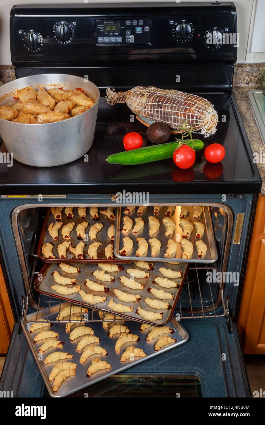 Preparing tasty food on electric stove in the kitchen for holidays ...