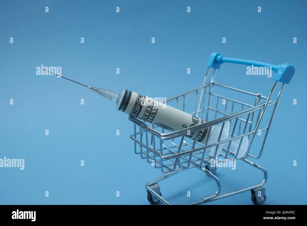 The syringe wrapped in a dollar is in the basket. Offering a financial ...