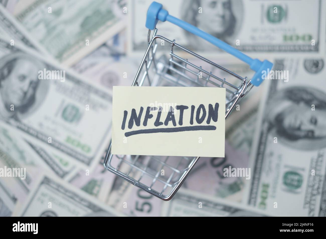 Shopping cart with inflation poster on a blurred background made of ...