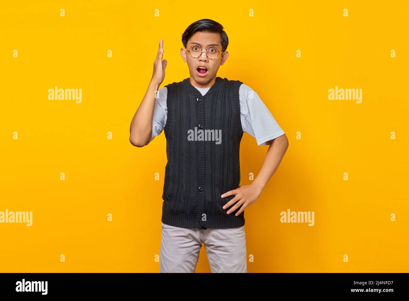Portrait of unhappy young Asian man having displeased expression and ...