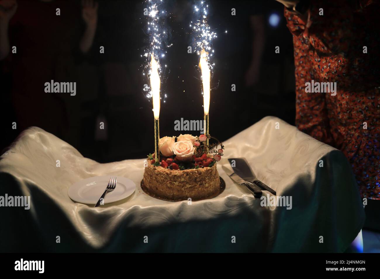 View of birthday cake with sparklers in restaurant Stock Photo - Alamy