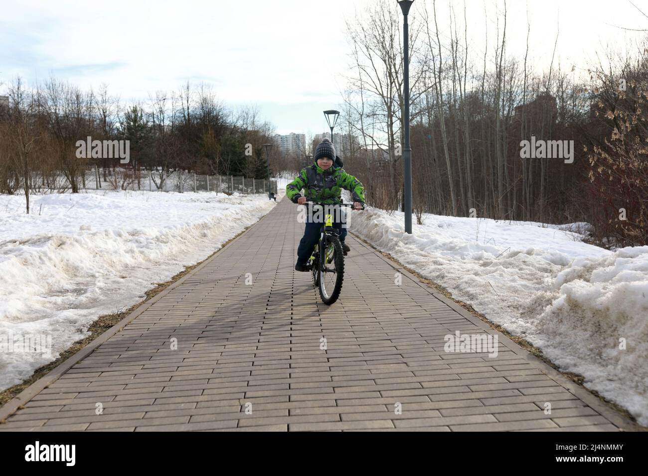 Child riding bike on sidewalk in spring Stock Photo - Alamy