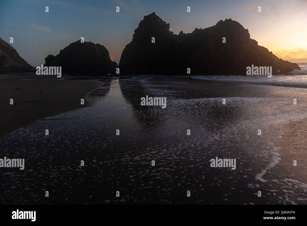Impression of the keyhole arch rock at Pfeiffer beach around sunset ...