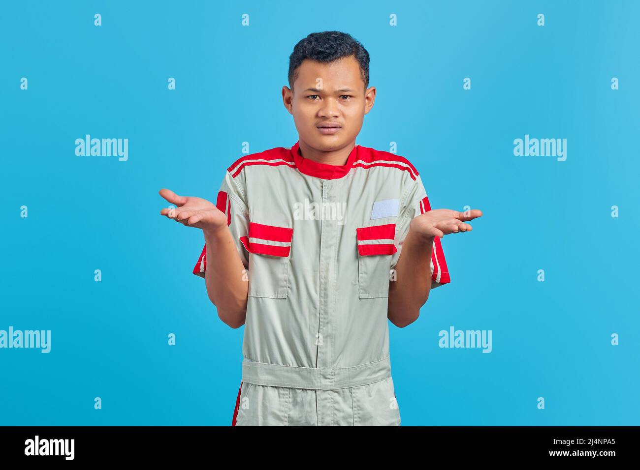 Shocked asian mechanic portrait with confused and displeased expression ...