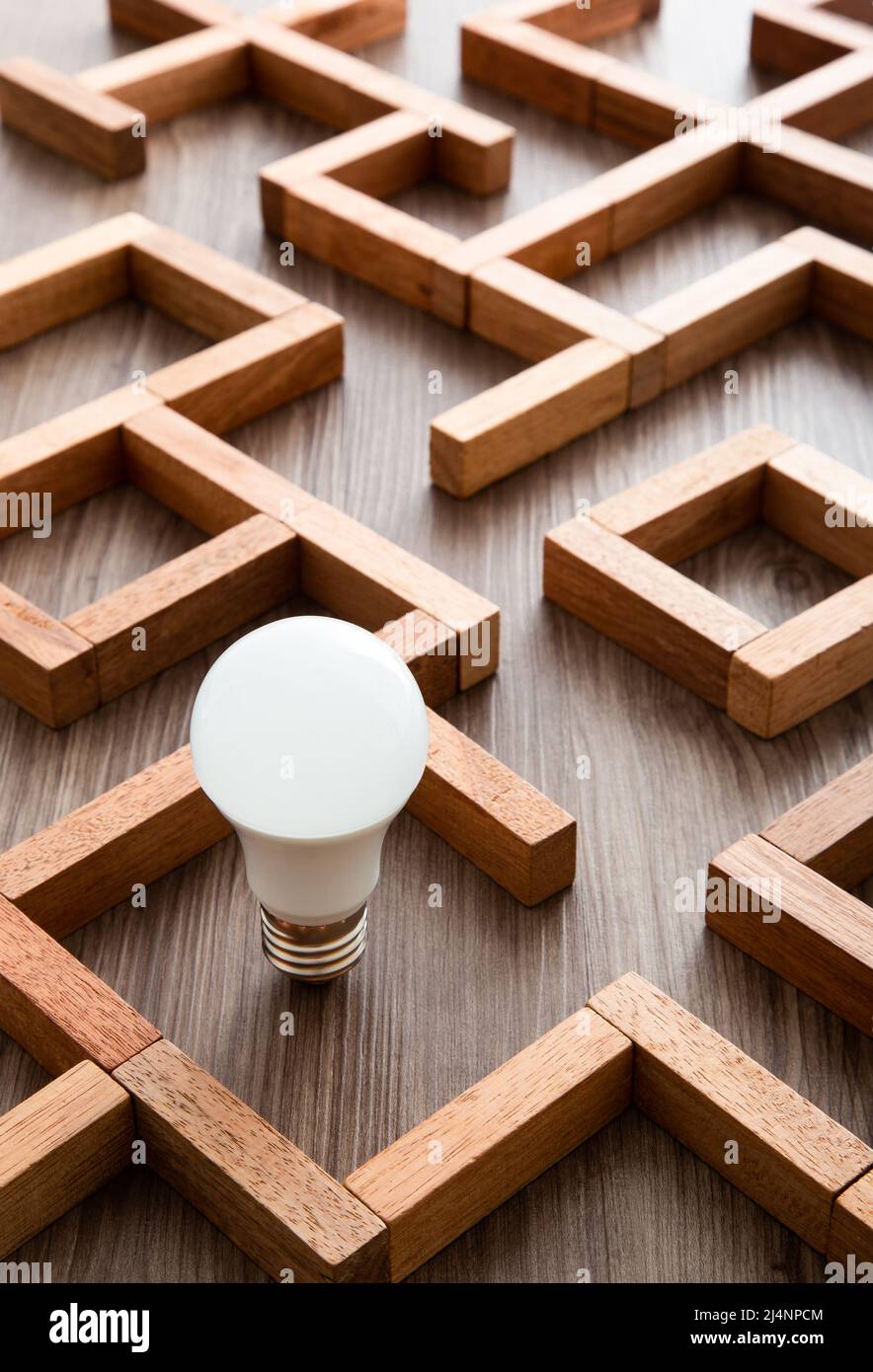 Light bulb in the maze game built by wood blocks, finding the right way ...