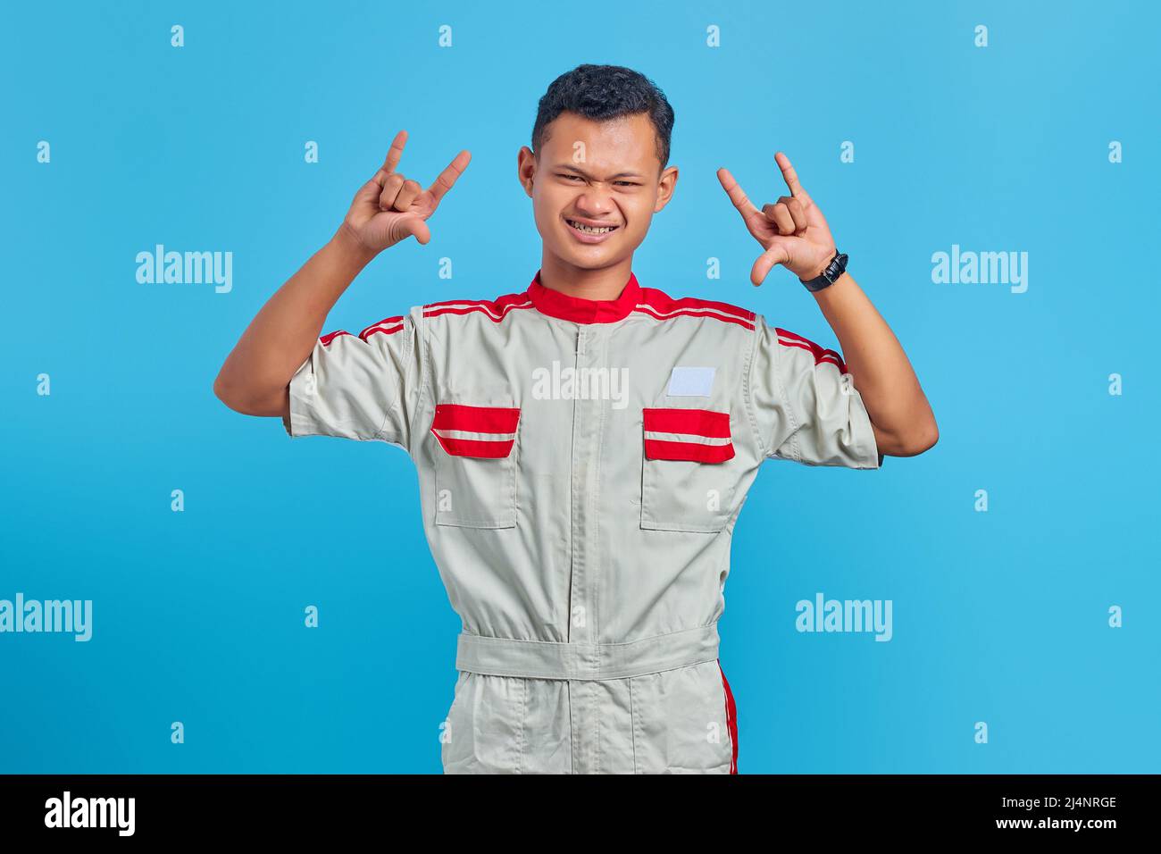 Portrait of young asian mechanic screaming with crazy expression doing ...
