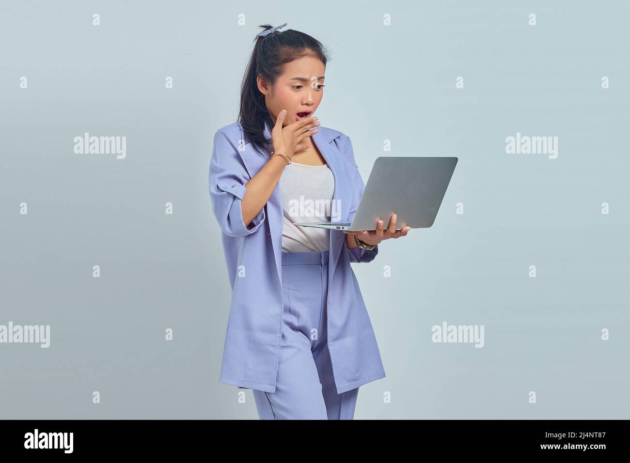 Portrait of surprised young Asian business woman looking at incoming ...