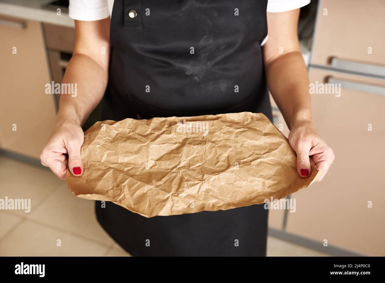 Wrapping paper in the hands of a housewife for packing various things ...