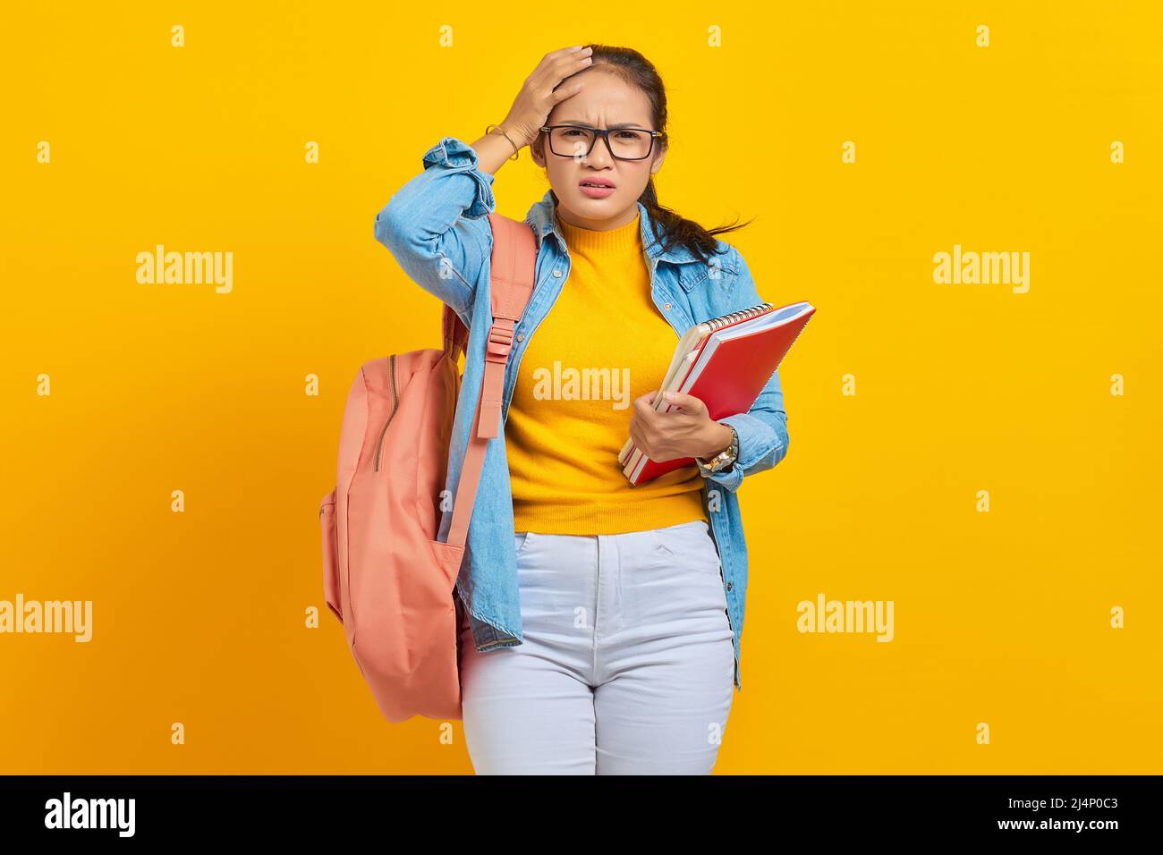Beautiful young Asian college student in denim outfit with backpack ...