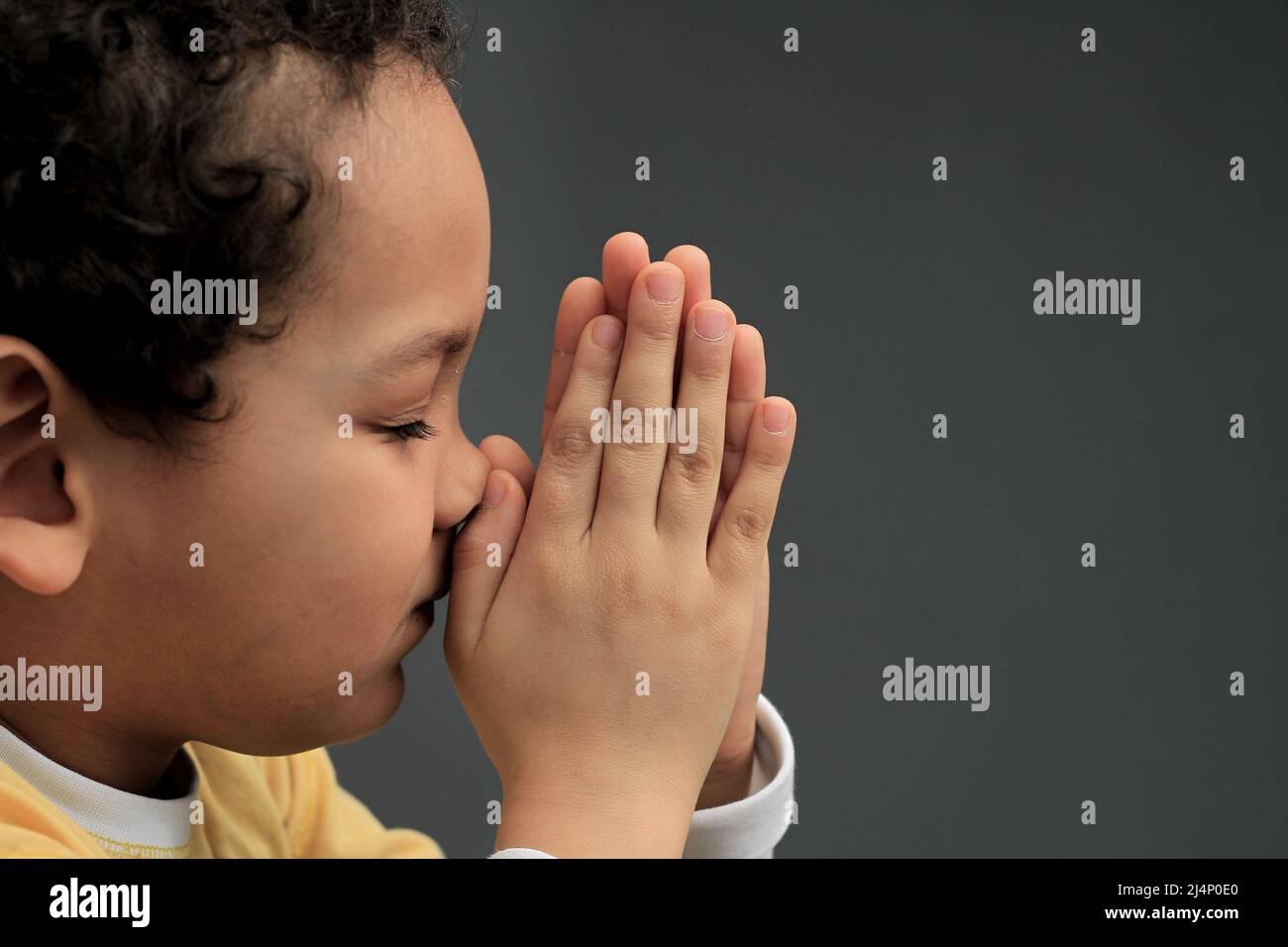 little boy praying to God with hands together stock photo Stock Photo ...