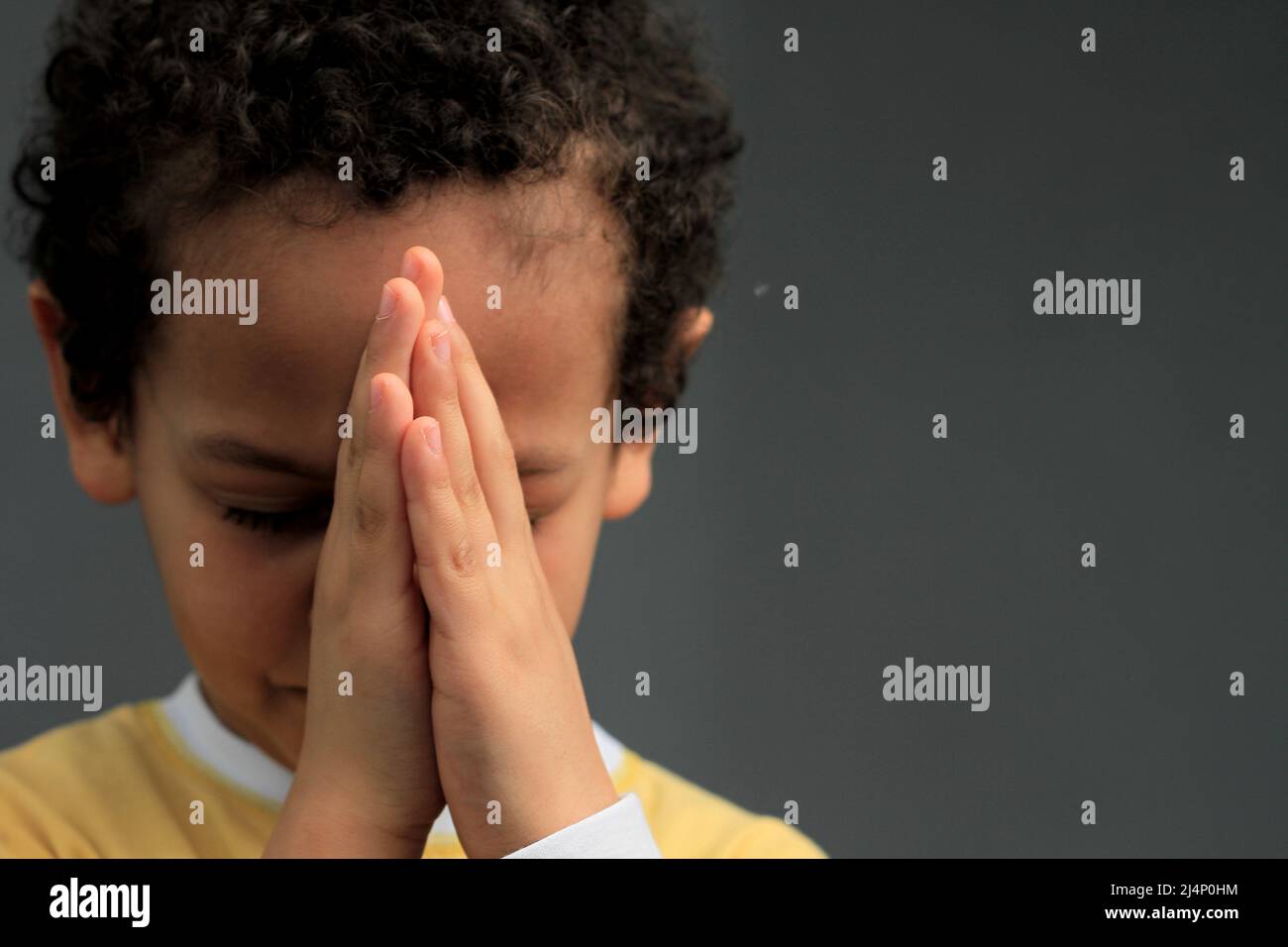 little boy praying to God with hands together stock photo Stock Photo ...