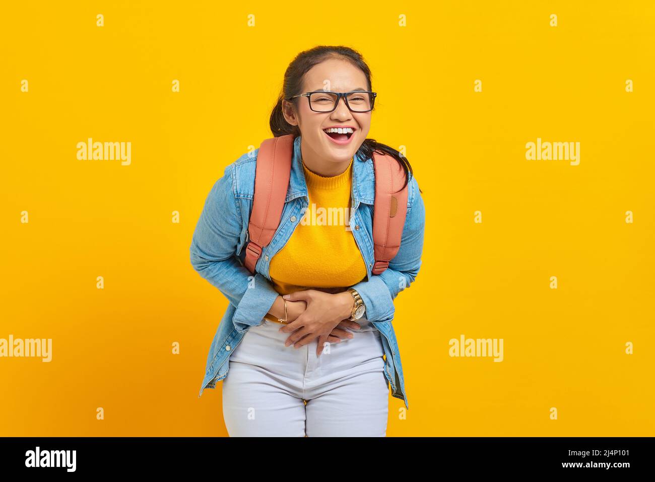 Beautiful young Asian woman student in denim outfit with backpack ...