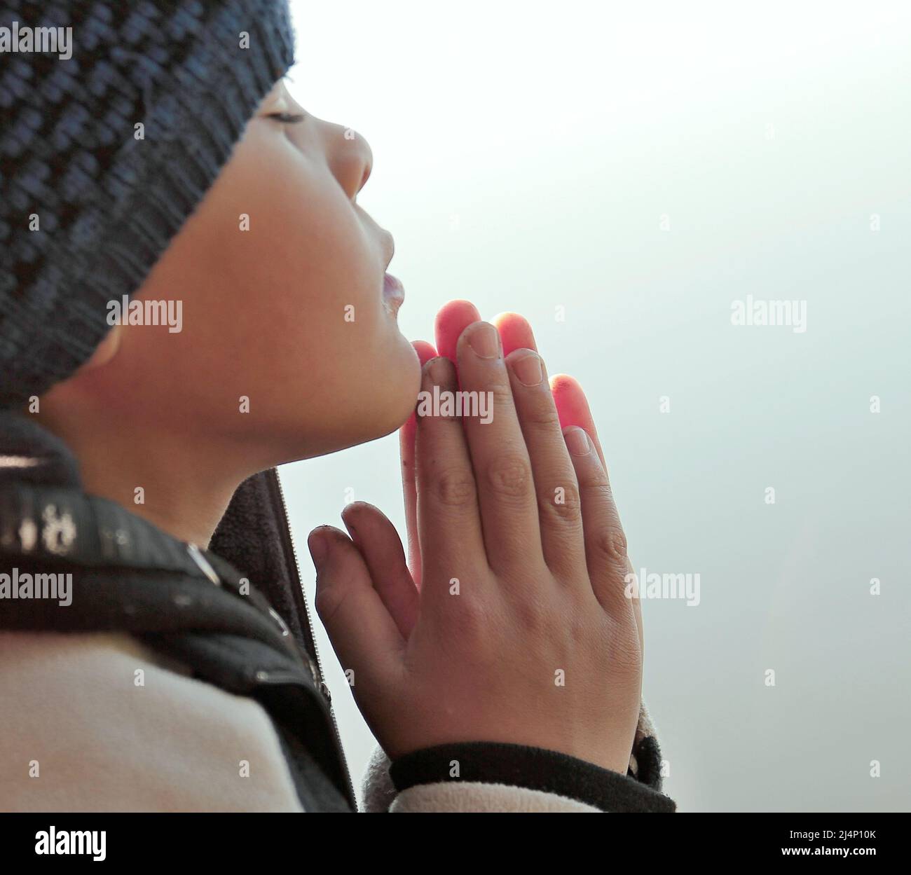 little boy praying to God with hands together stock photo Stock Photo ...