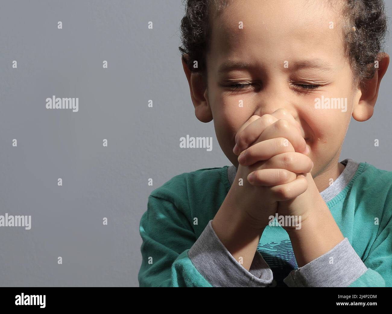 little boy praying to God with hands together stock photo Stock Photo ...