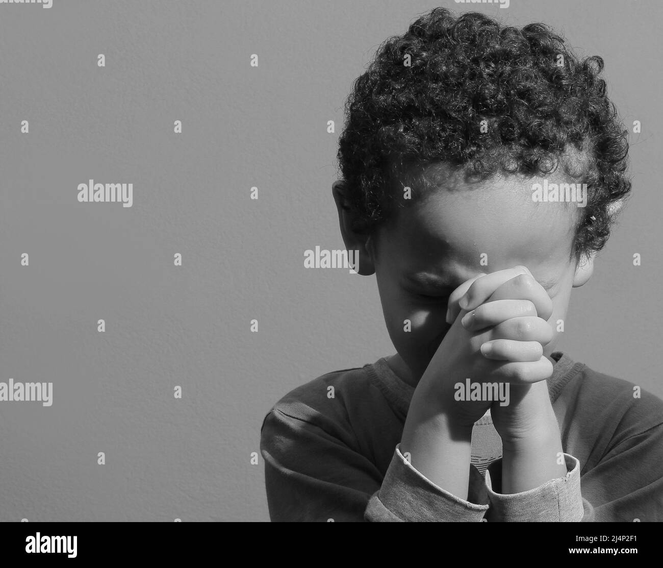 little boy praying to God with hands together stock photo Stock Photo ...