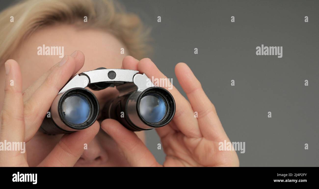 looking through binoculars on grey black background with people stock ...