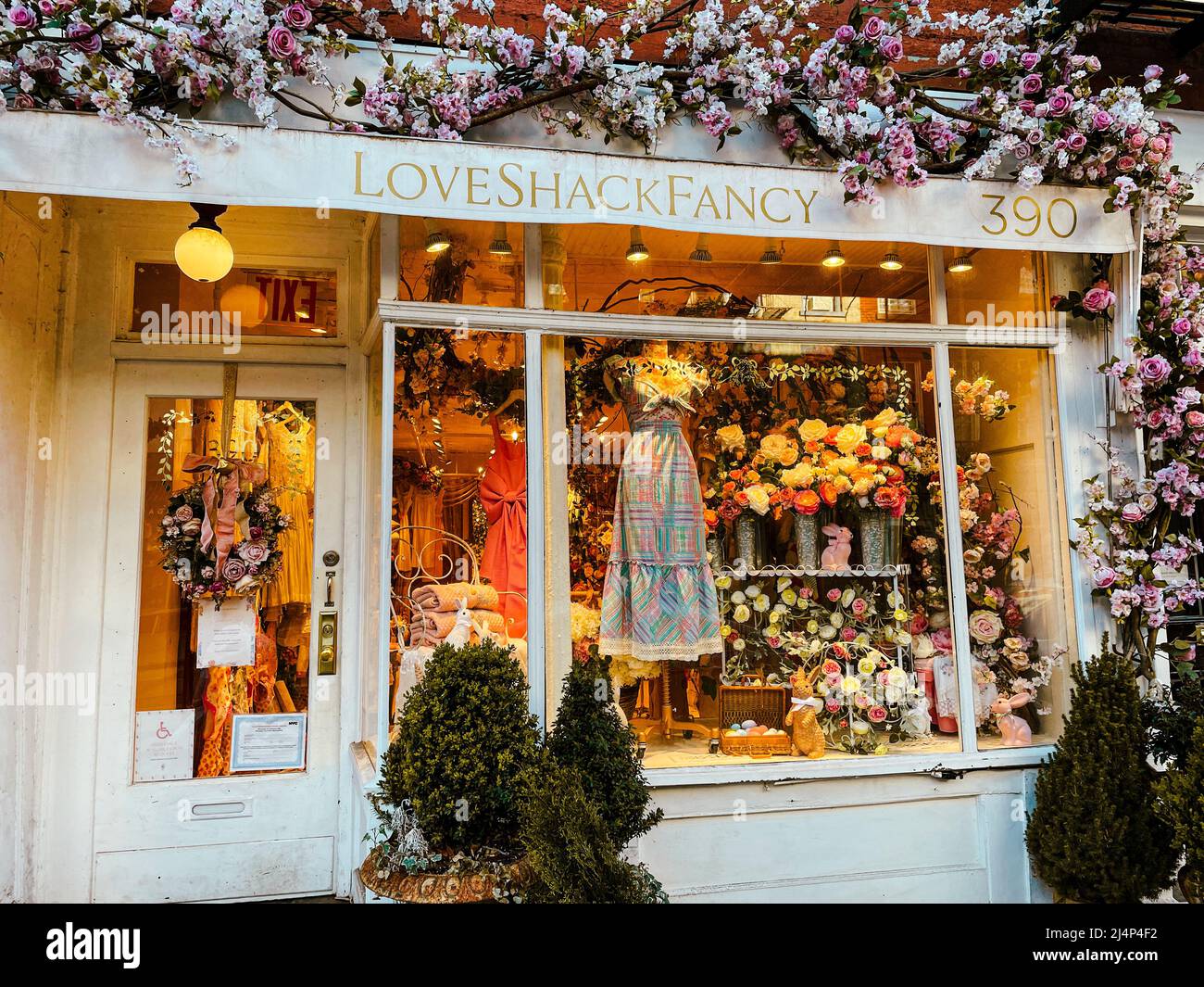 storefront of LoveShackFancy retail store decorated with spring flowers ...