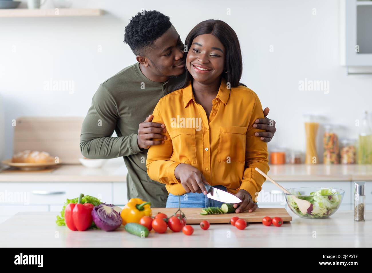 Happy black couple cooking healthy food together at home Stock Photo ...