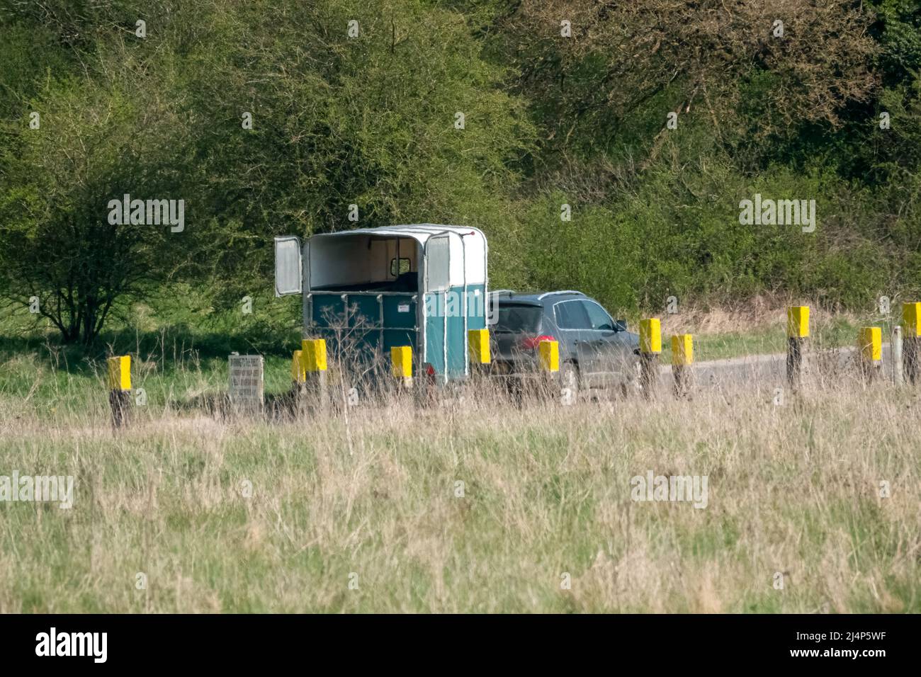 large dark red coach work horse transport lorry in motion through open ...