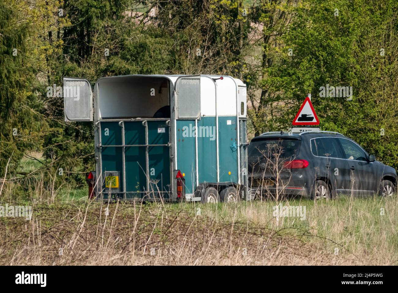 large dark red coach work horse transport lorry in motion through open ...
