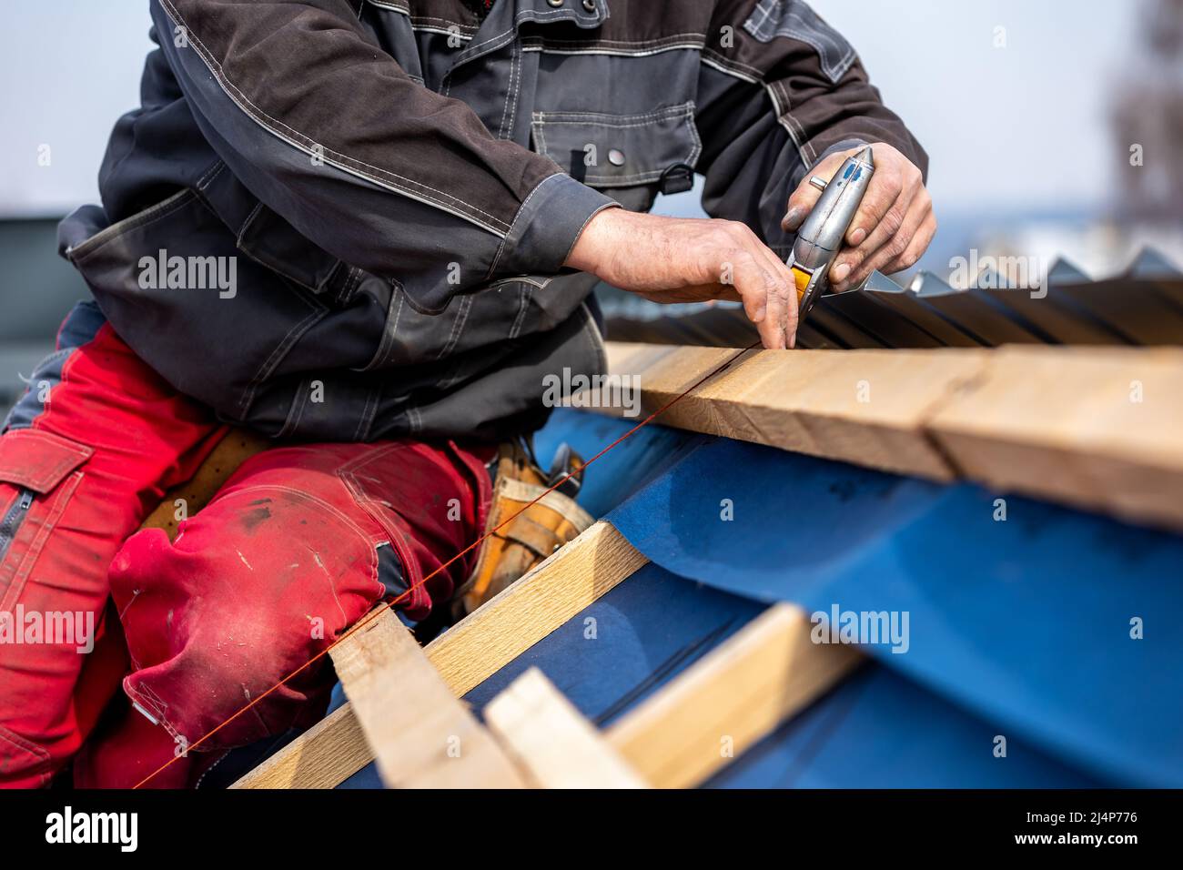 Craftsman or construction worker install a new roof, roofing tools, new ...