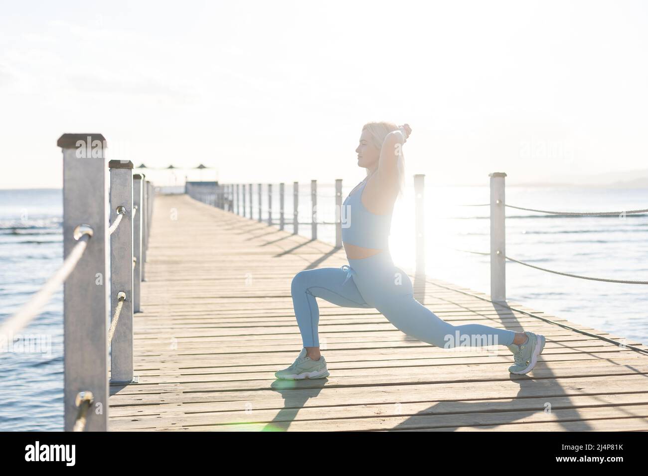 Woman doing yoga exercises by the sea Stock Photo - Alamy