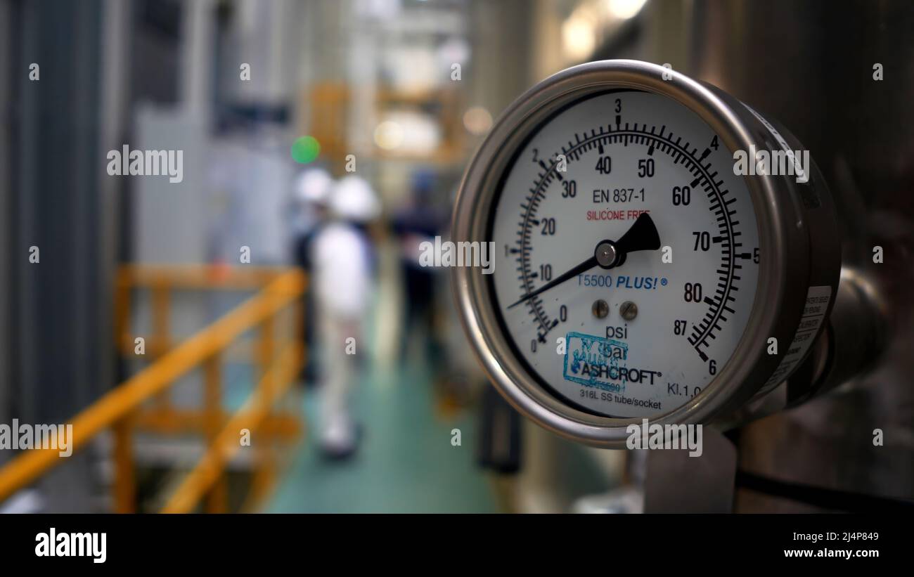 Close up of hydraulic pressure gauge at the factory. Scene. Blurred ...