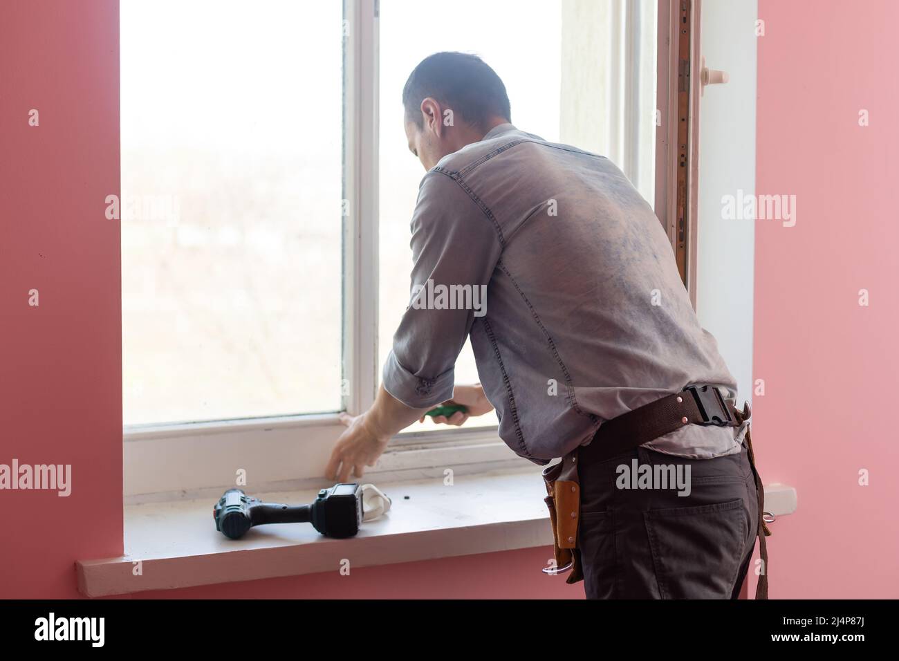 The worker installing and checking window in the house Stock Photo - Alamy