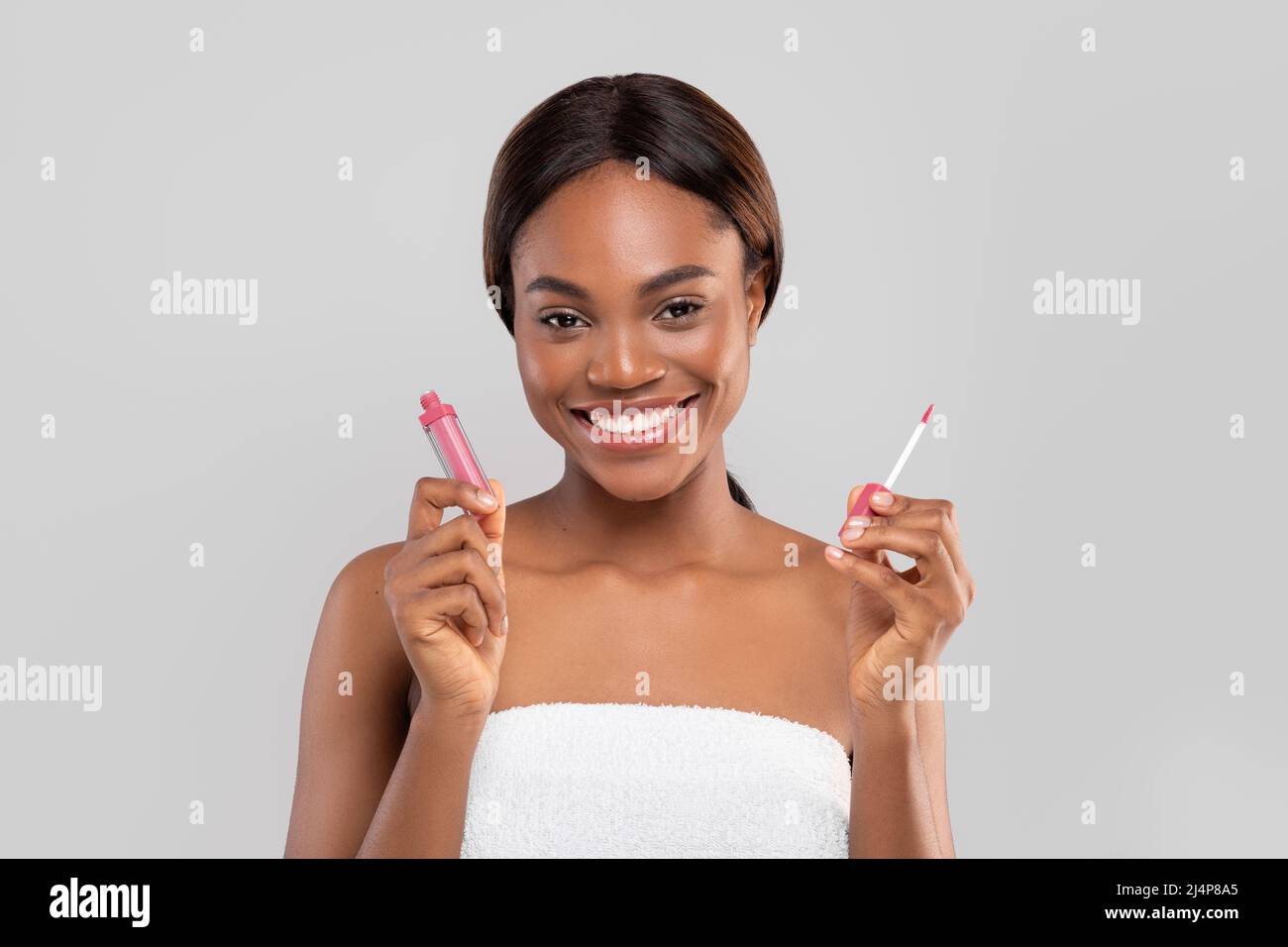 Happy pretty young african american female with perfect skin in towel ...