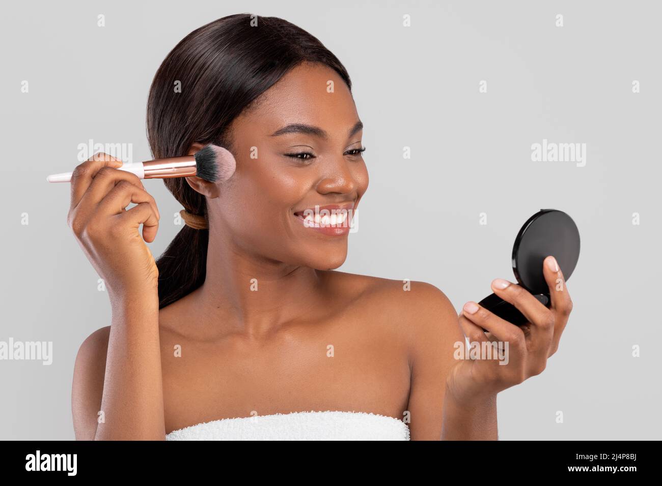 Smiling pretty young african american woman with perfect skin in towel ...