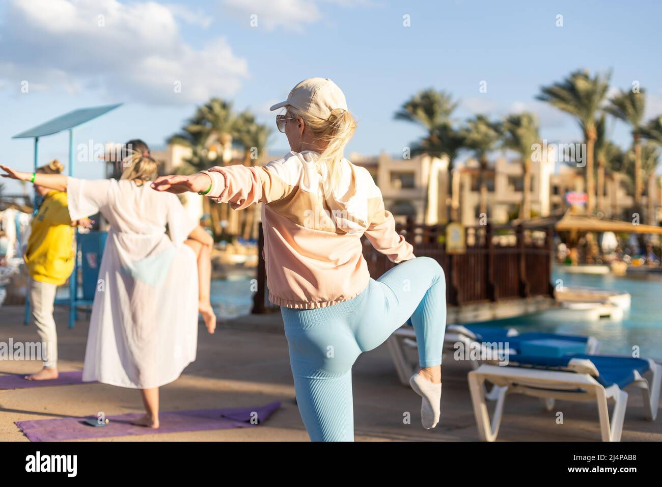 group sports exercises near hotel lounge chairs. active sports at the ...