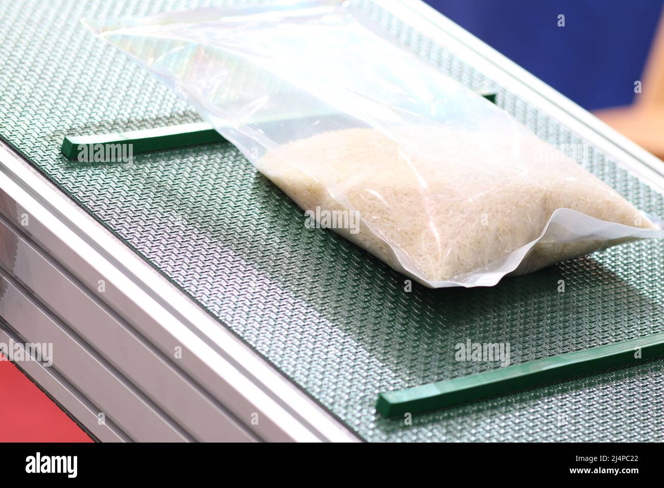 rice packing in plastic bag on conveyor line ; close up Stock Photo - Alamy