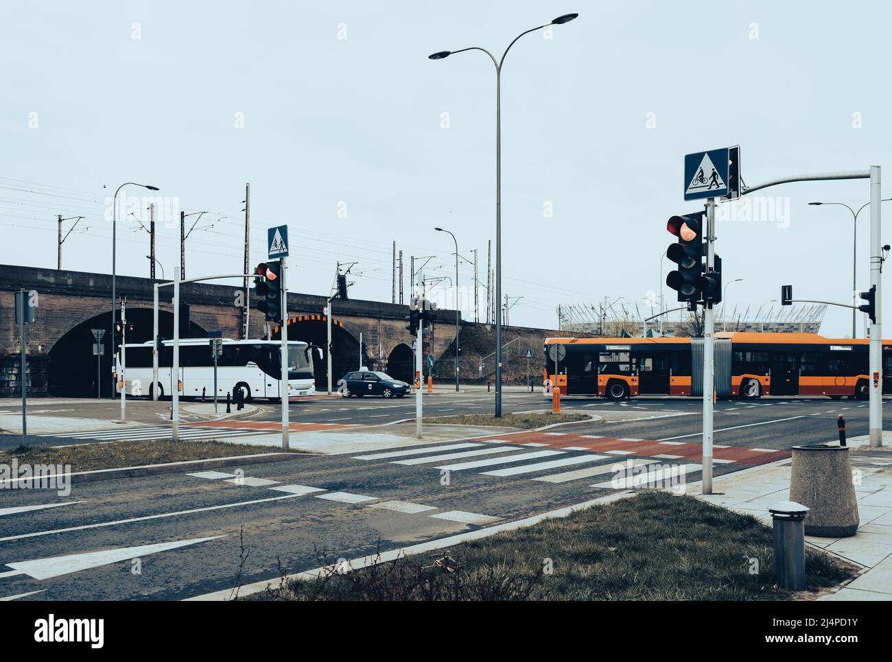 Buses pass at the crossroads. Traffic is regulated by traffic lights ...