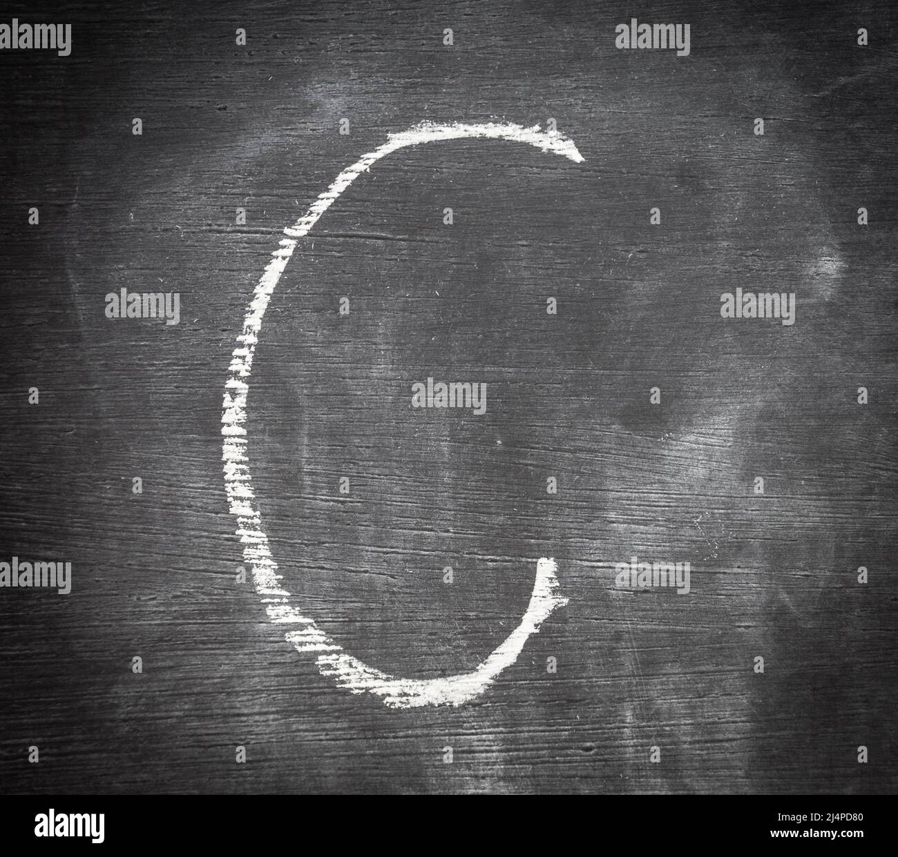 C - letter written on black chalkboard Stock Photo - Alamy