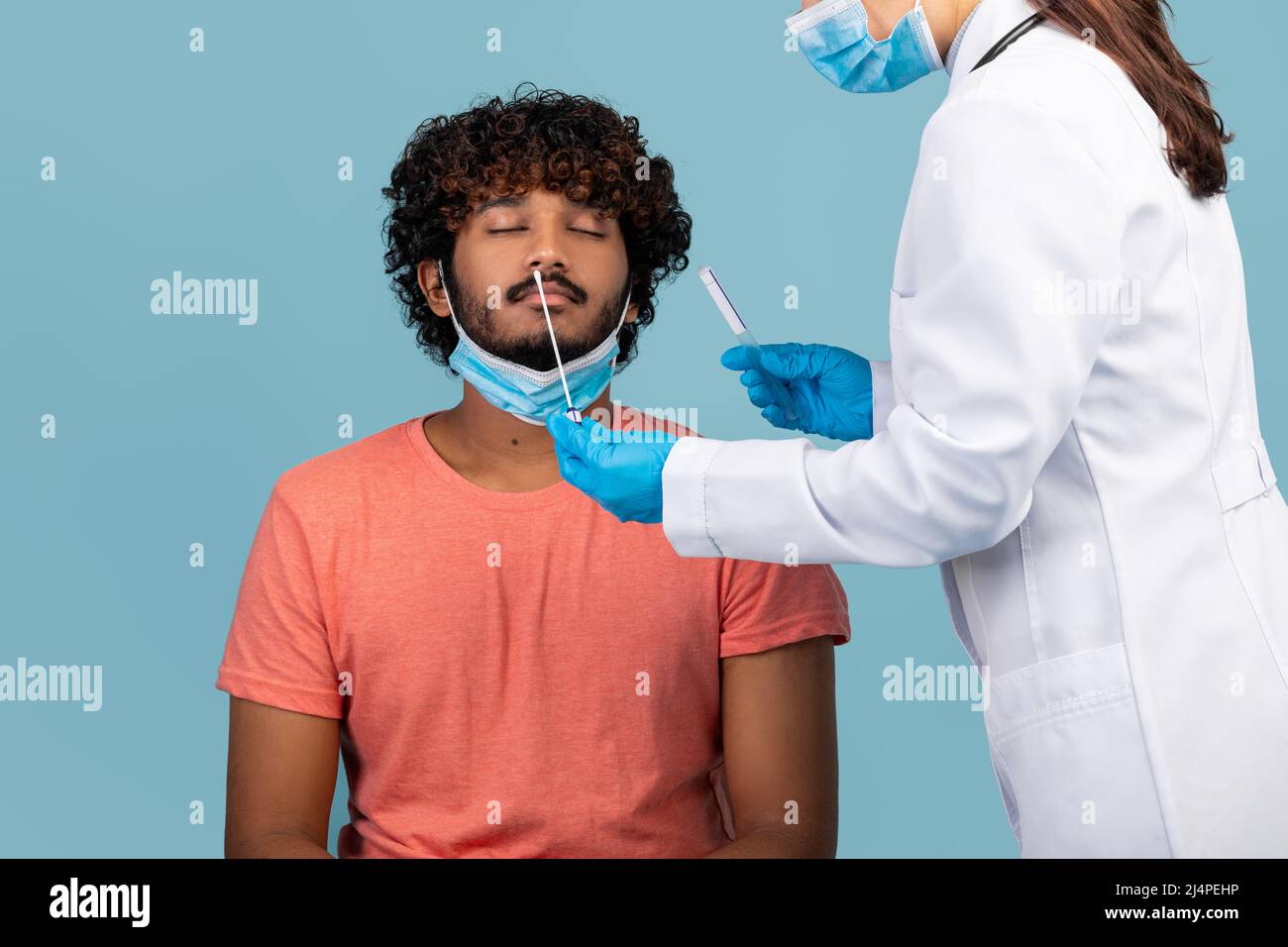 Nurse holding swab, making nasal PCR coronavirus test for man Stock ...