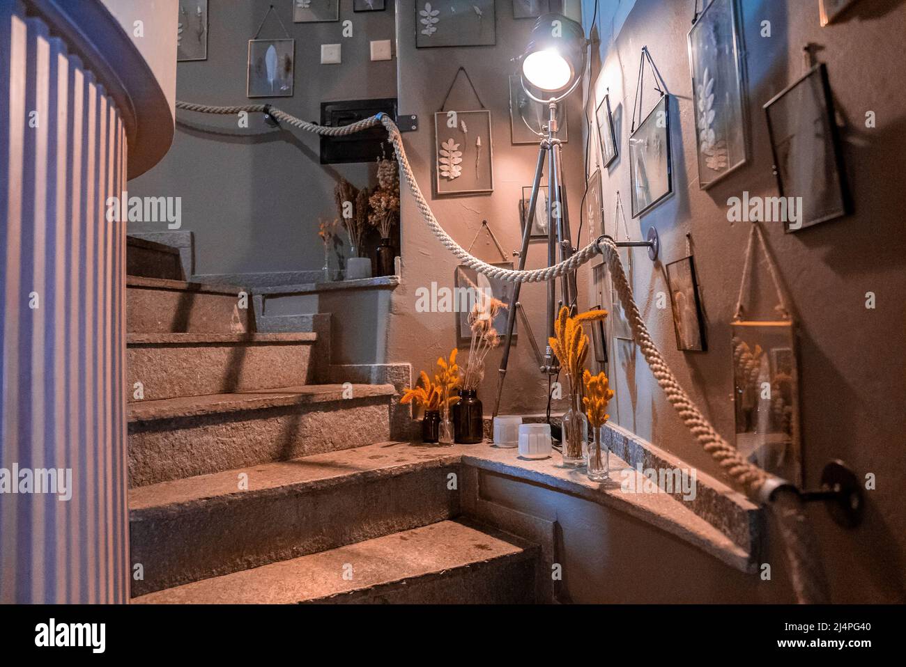Frames hanging on illuminated wall by steps in luxurious stylish hotel ...