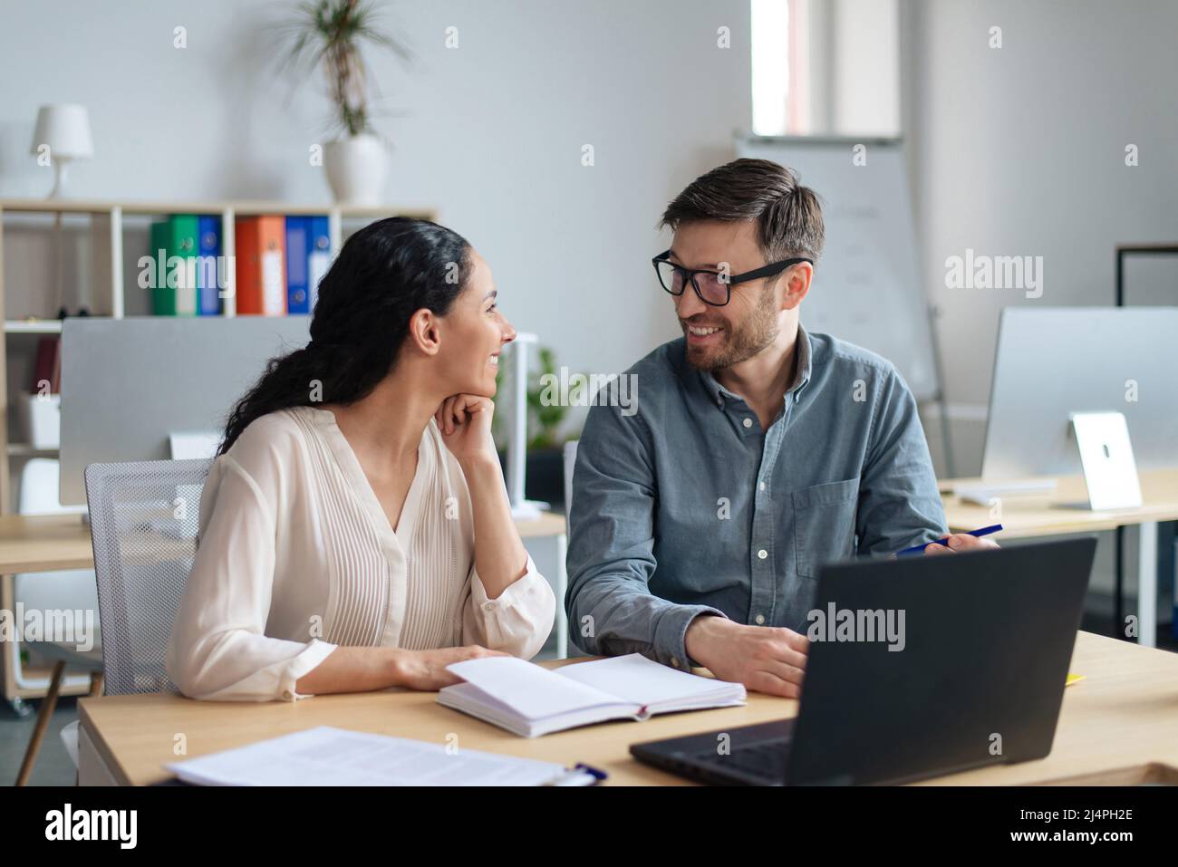 Teamwork and collaboration concept. Happy young coworkers having ...