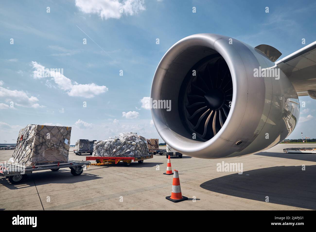 Preparation freight airplane at airport. Loading of cargo containers ...