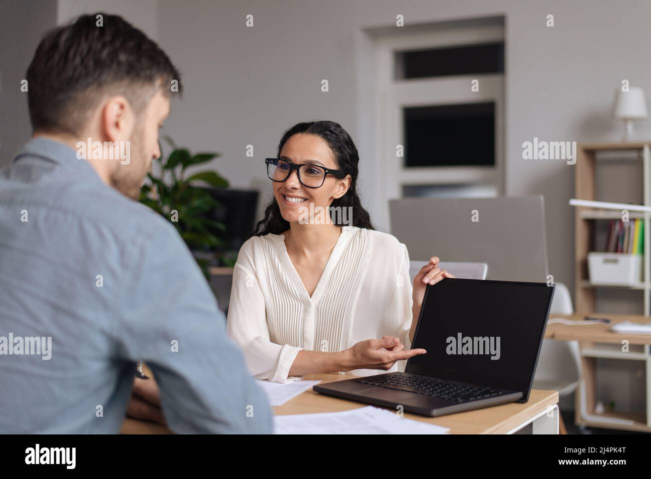 Happy millennial colleagues working together on online business project ...