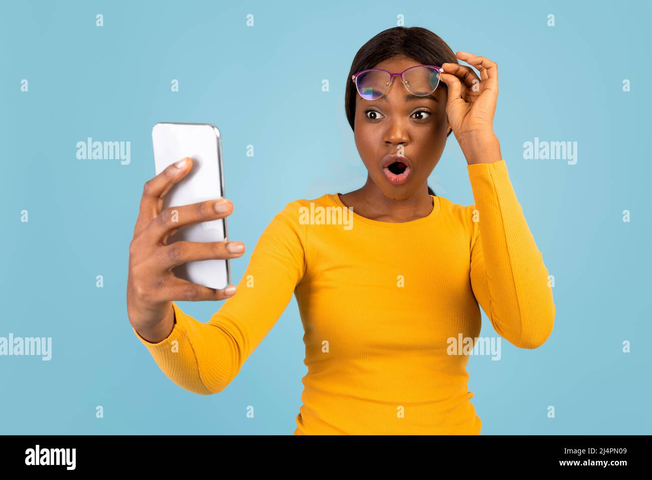 Shocked Young Black Female In Yellow T Shirt Takes Off Glasses And